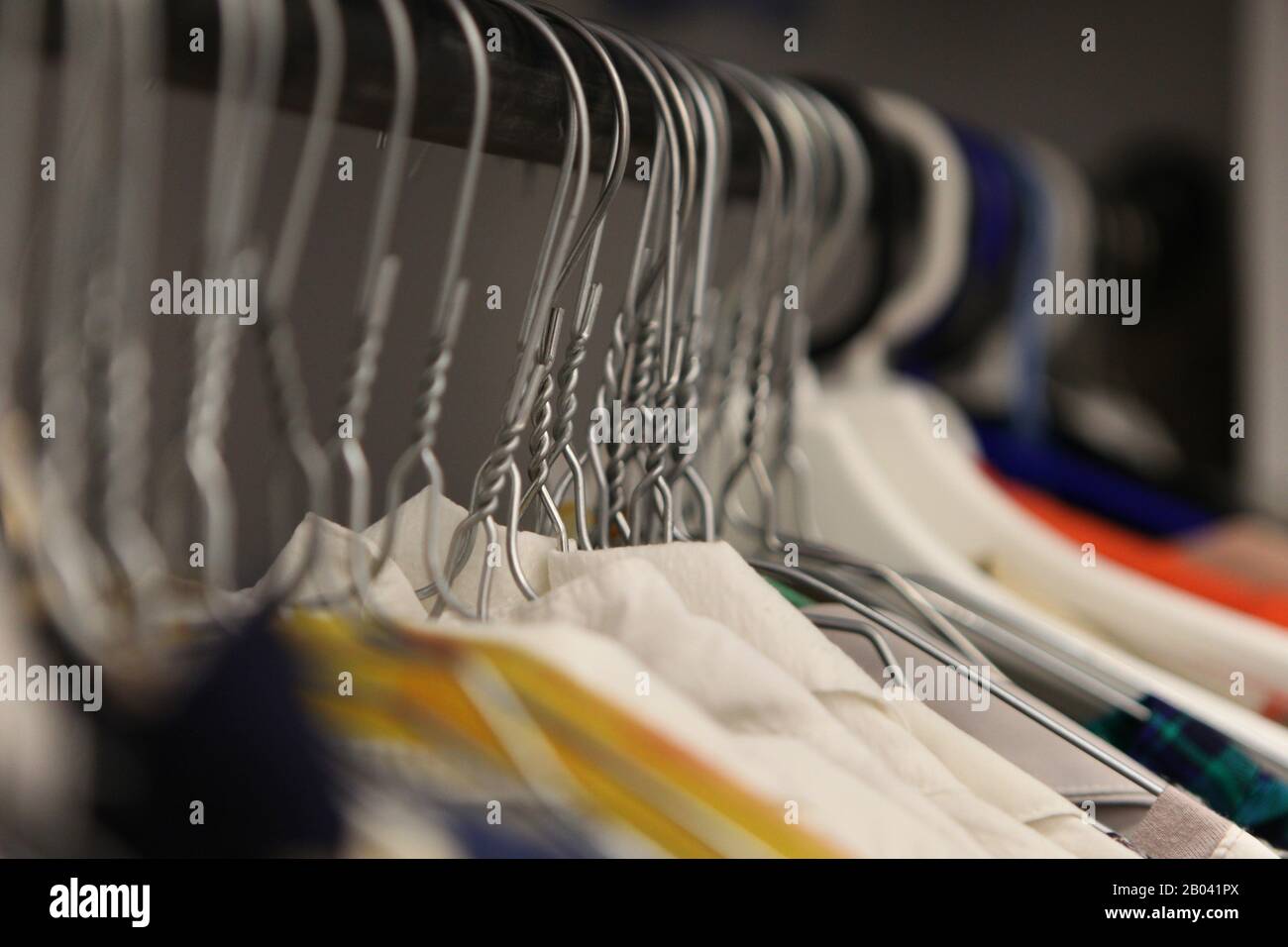 clothes hanger closeup of fashion shop. aluminium hanger with clothes ...