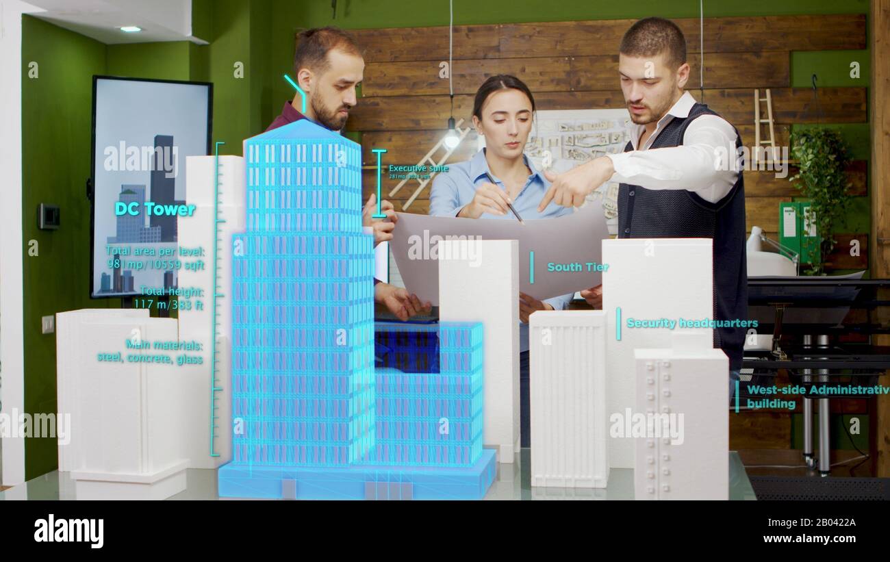 Team of architects working on city skyscrapers using augmented reality ...