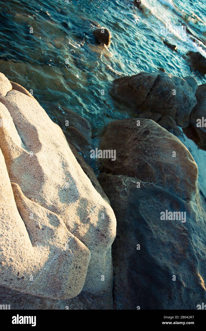 Pile of stones and the sea behind / Beautiful coast in Greece while sun ...