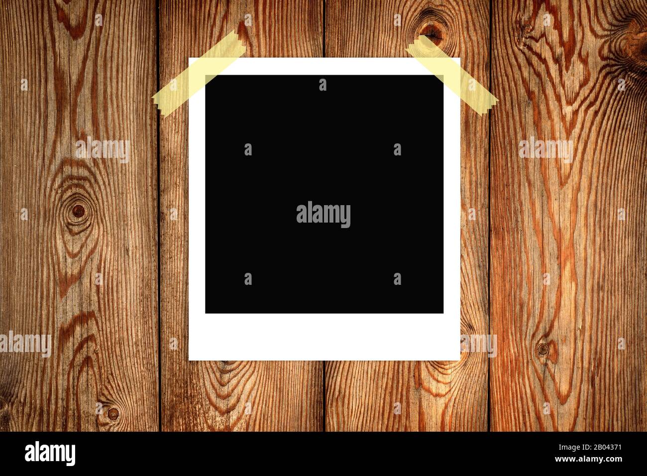 photo attached on a wood background with adesive tape Stock Photo - Alamy