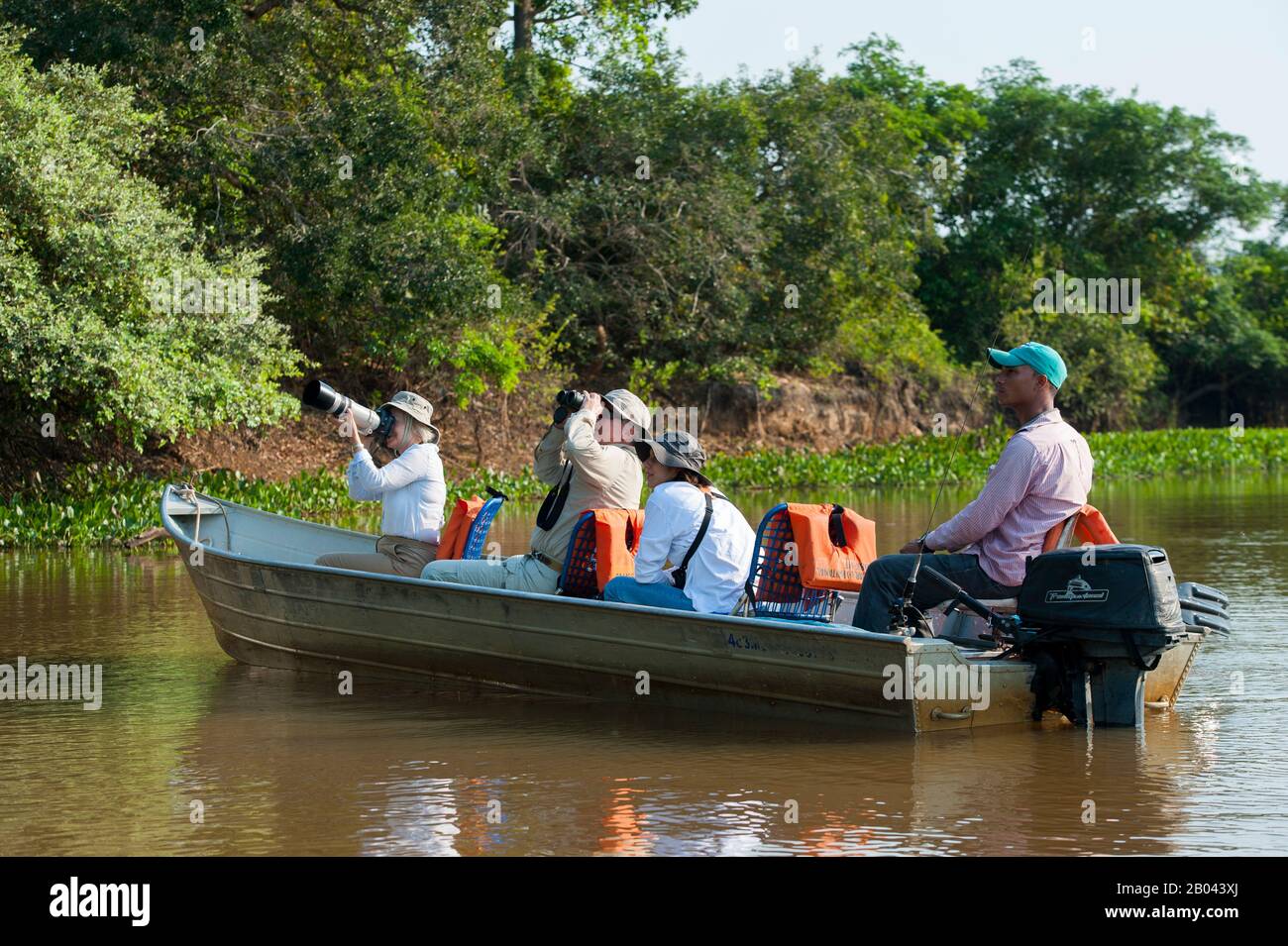 Tourists in boat on excursion to watch and photograph the wildlife in ...