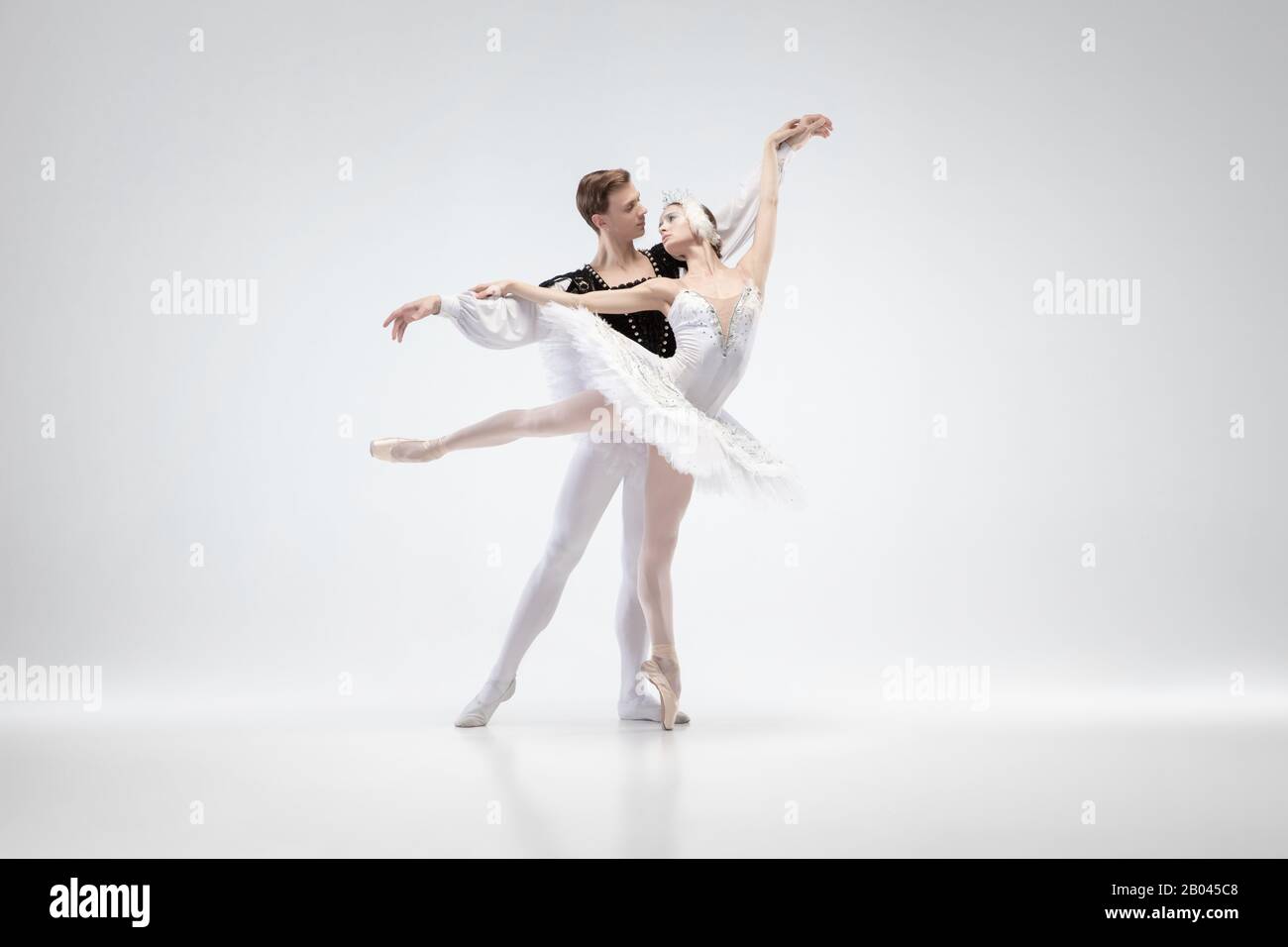 Love. Graceful classic ballet dancers dancing isolated on white studio ...