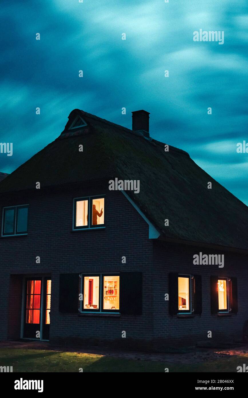 Night illuminated windows man home hi-res stock photography and images ...