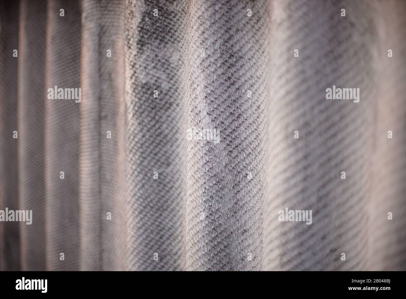 Grey asbestos cement slate fence. Perspective view Stock Photo - Alamy