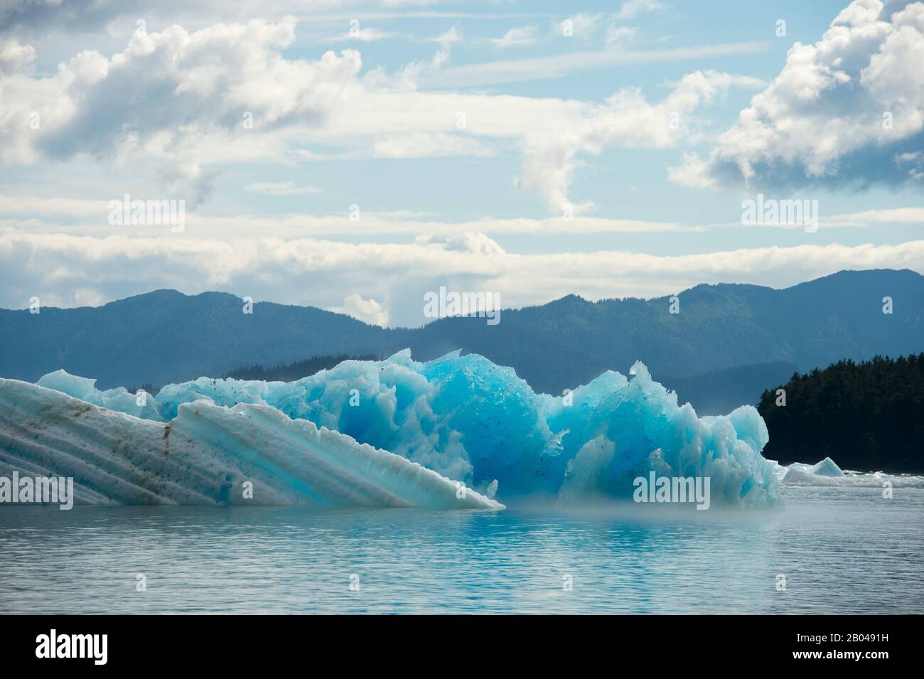 Ice fog developing at base of icebergs from LeConte Glacier drifting in ...