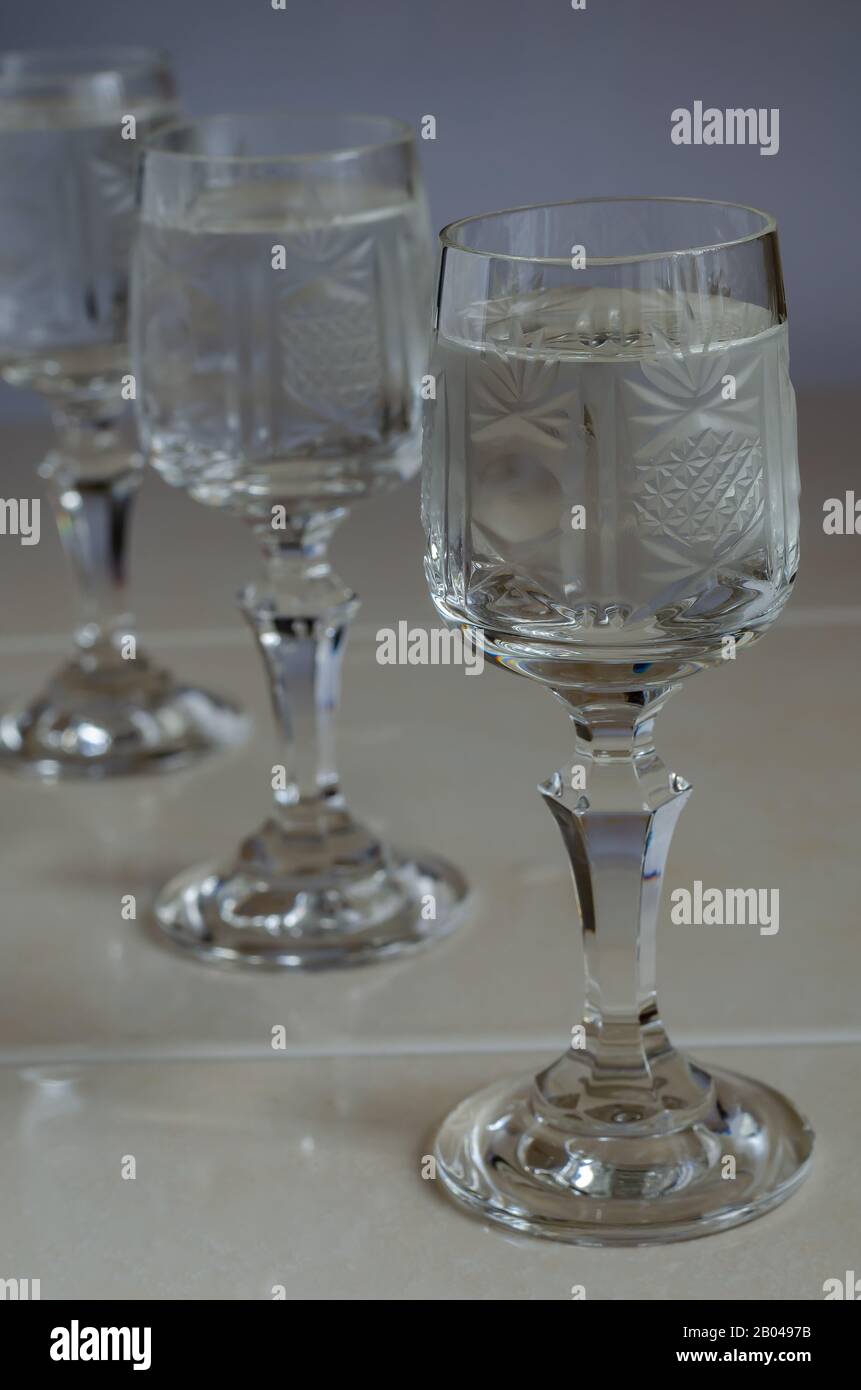 Three glasses of vodka in a line. Close-up. Eye level shooting ...