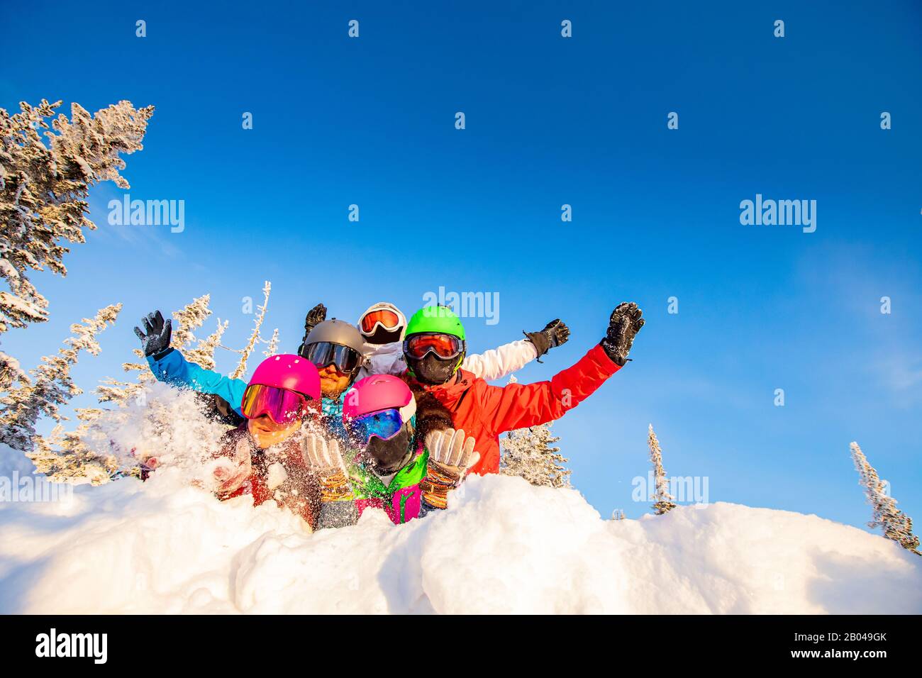 Group of happy friends having fun in winter forest. Snowbarders and ...
