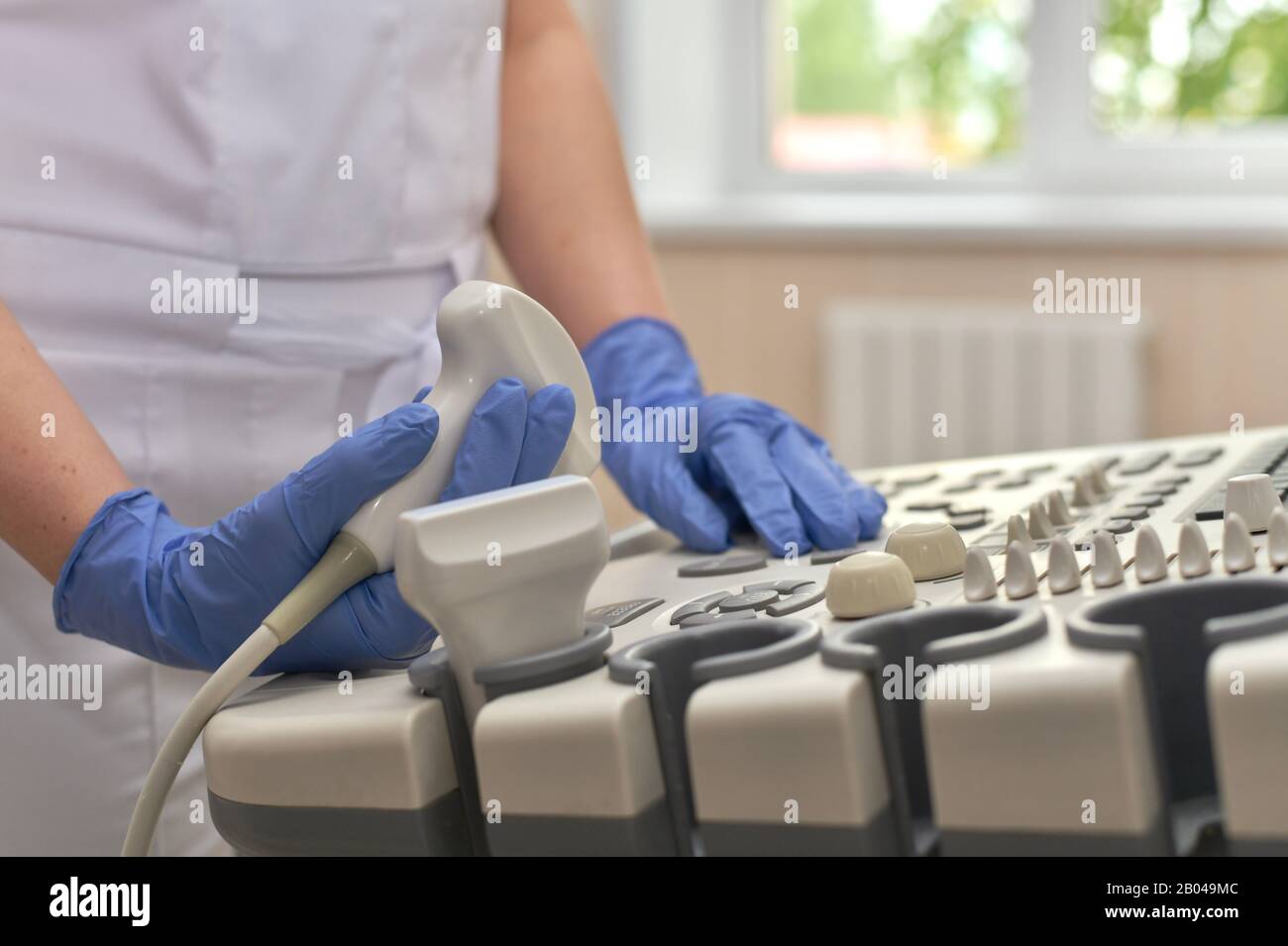 Ultrasound examination, the hand with the sensor lies on the panel, in ...