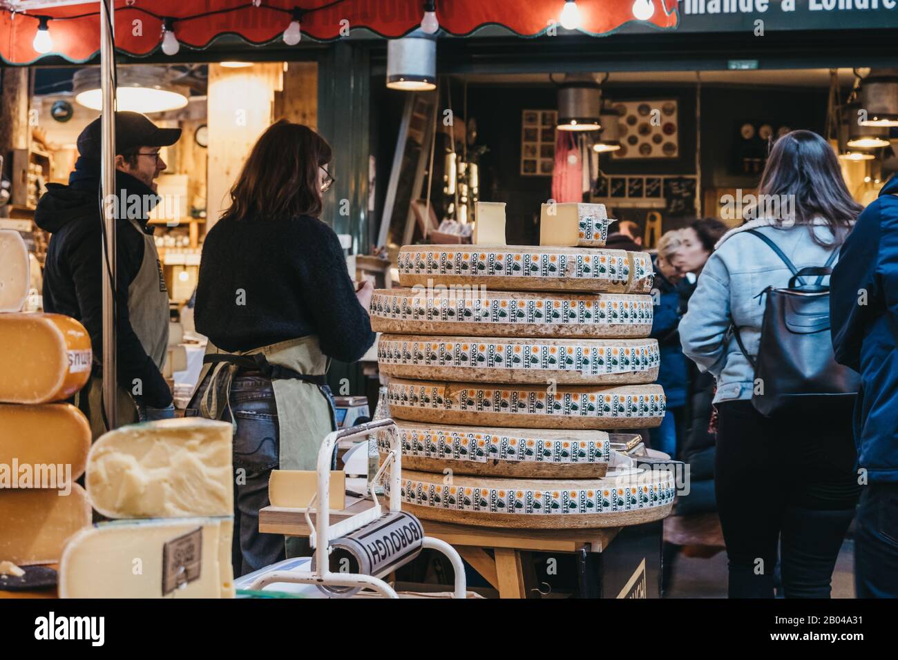 London, UK - November 29, 2019: Wheels of cheese on sale at a stand ...