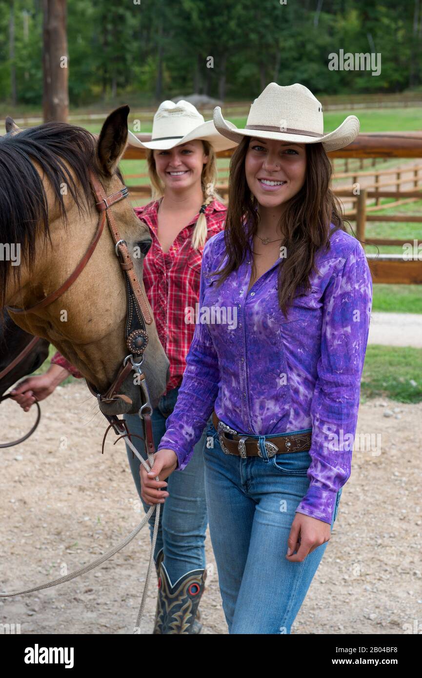 Cowgirl (Wrangler) with horse at Averill's Flathead Lake Lodge, a dude ...