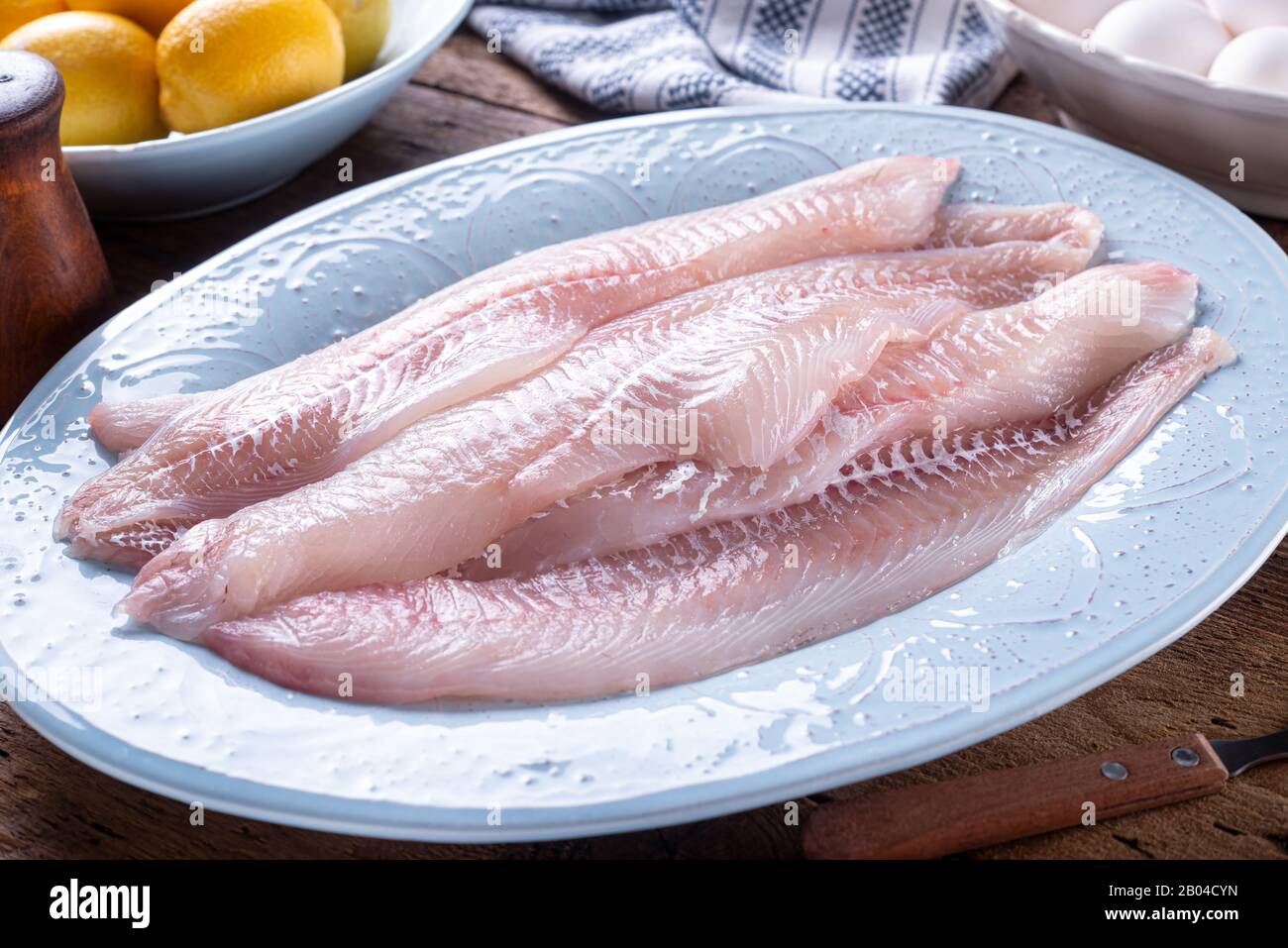 Fresh haddock fillets on a rustic wood table top Stock Photo - Alamy