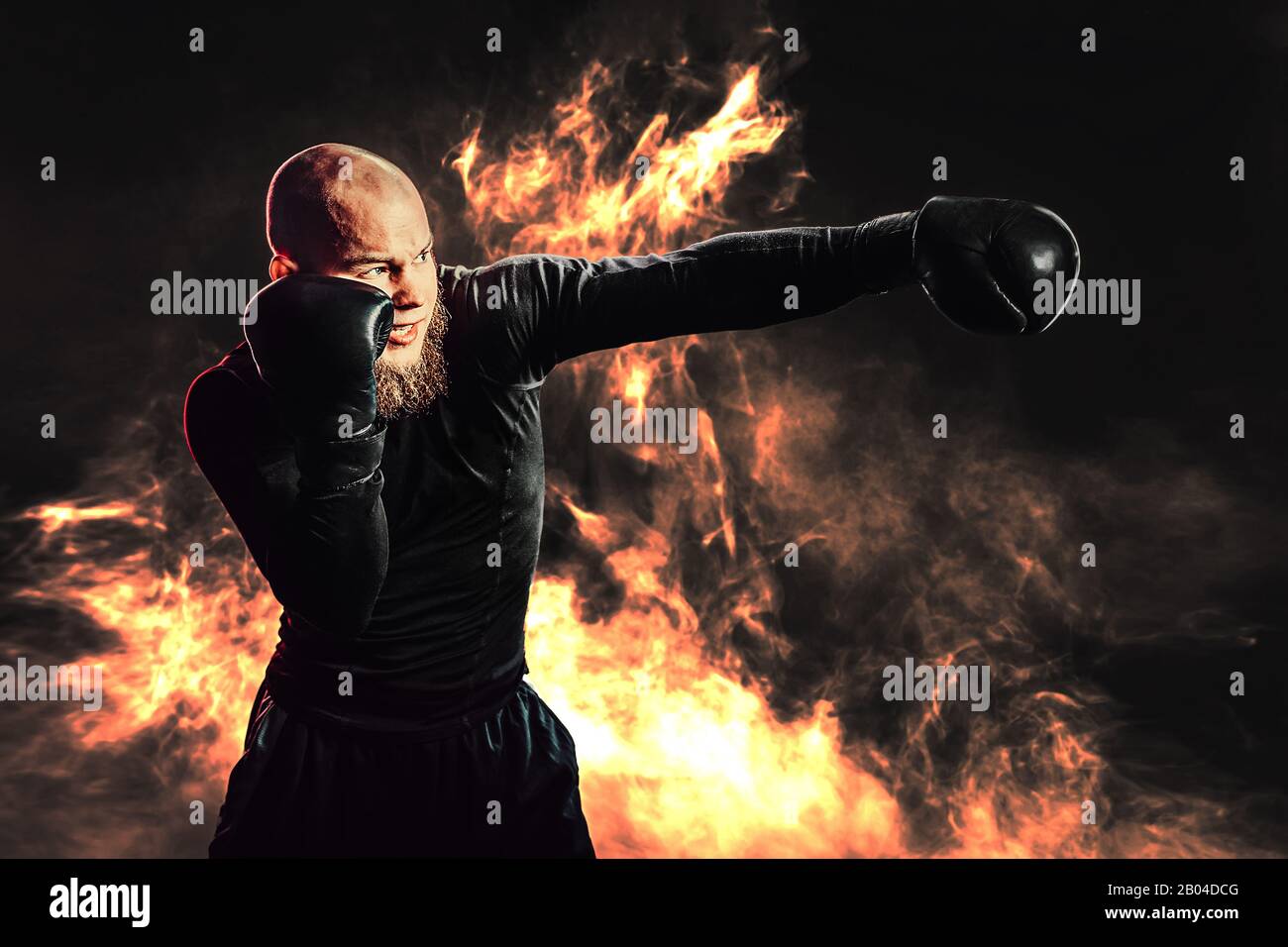 Sportsman boxer training, hitting direct hit on background with fire ...