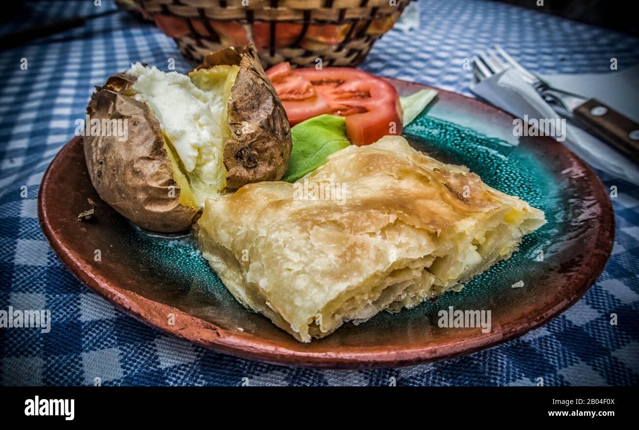 Serbian traditional appetizer with cheese pie and baked potato with ...