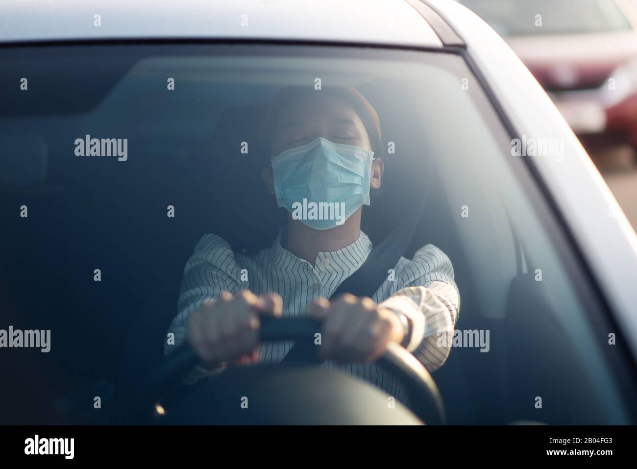 Asian girl wearing face mask in a car outdoors Stock Photo - Alamy