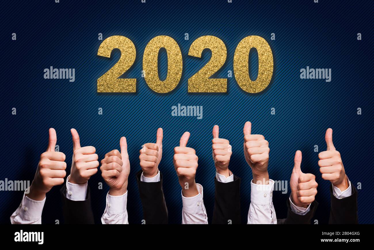 many thumbs up in front of wall with message 2020 Stock Photo - Alamy