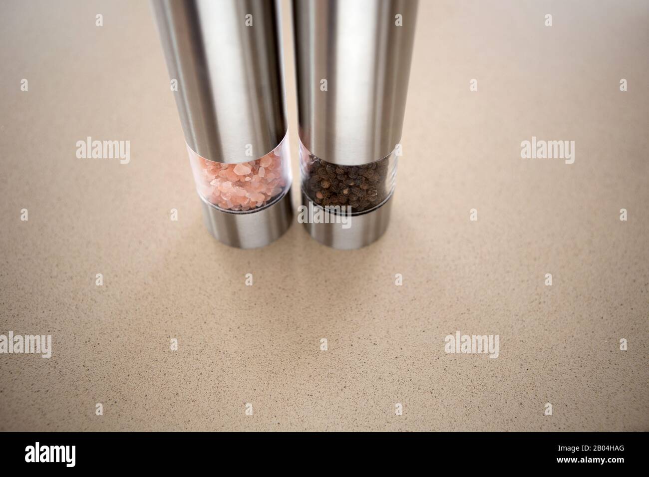 salt and pepper grinders on gray kitchen countertop Stock Photo - Alamy