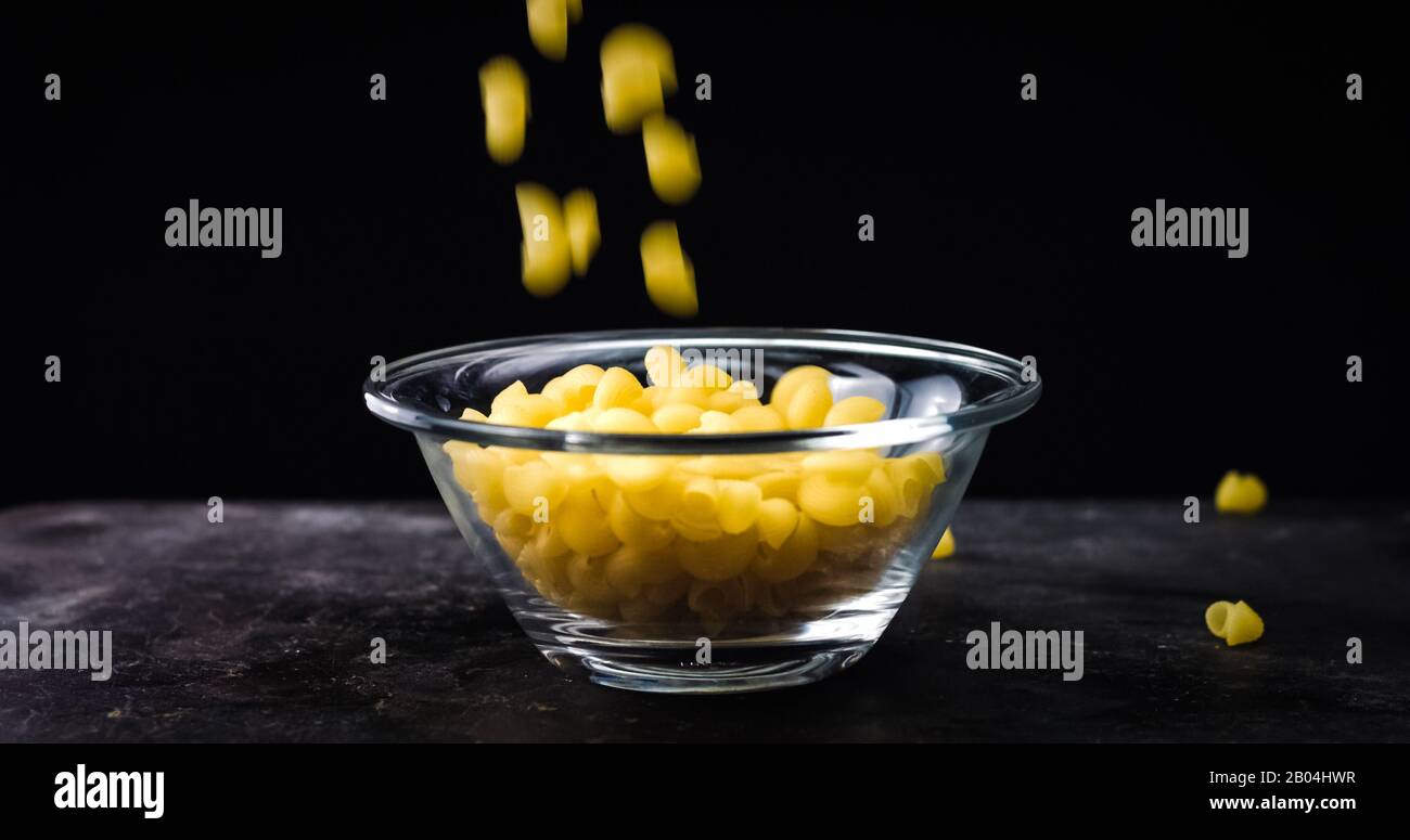 Raw pasta falling on heap hi-res stock photography and images - Alamy