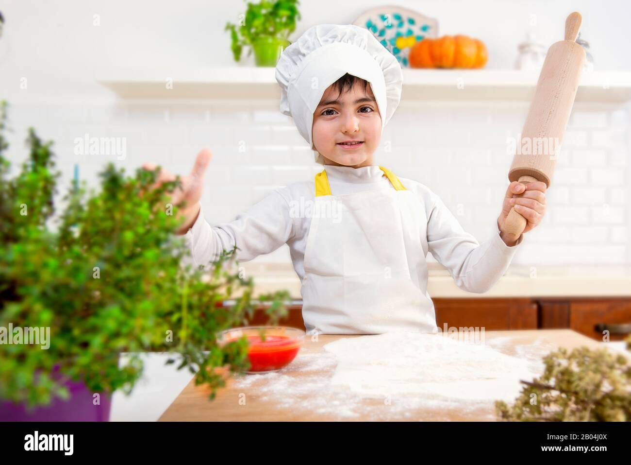 home setting for a nice happy child cooking Stock Photo - Alamy