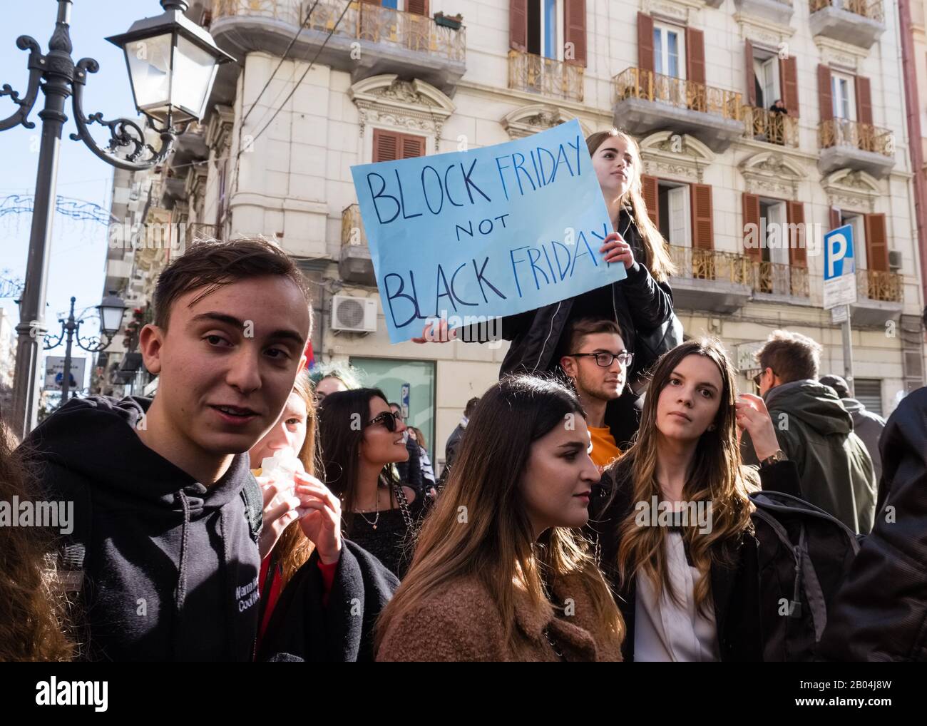 Girl on the back of a companion shows a sign protesting against climate ...