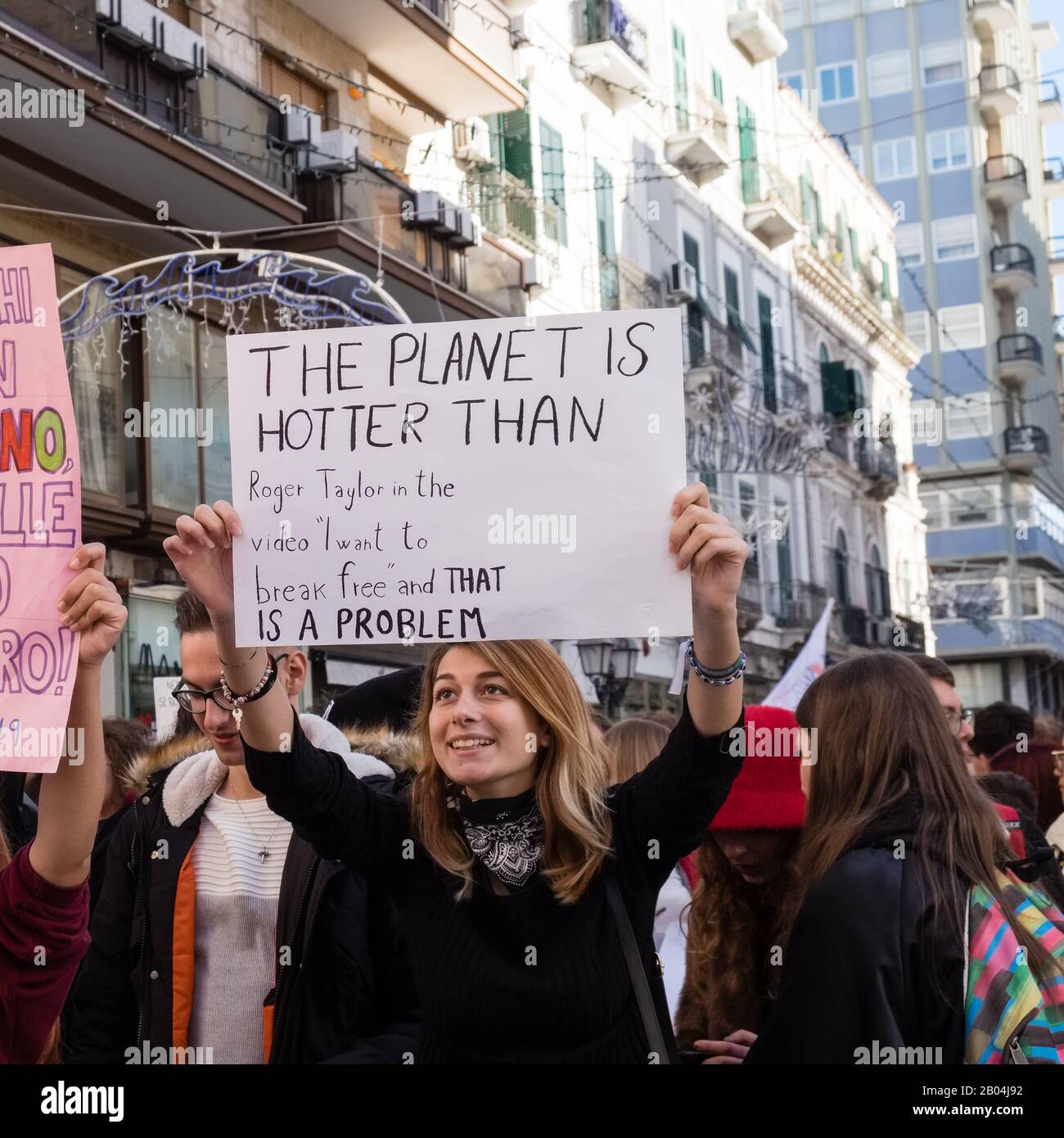 Young girl protests against climate change by showing a sign with ...