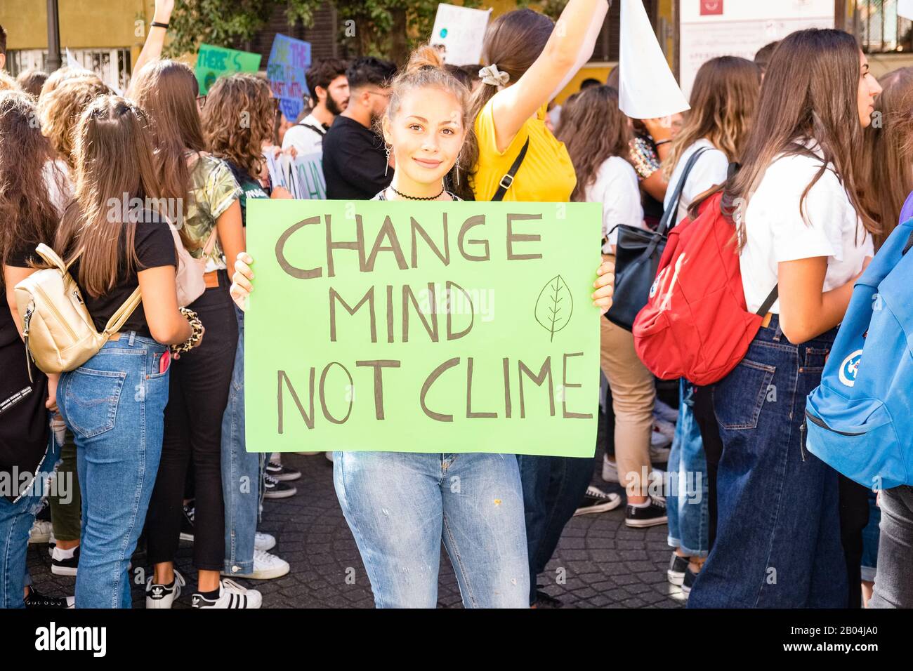 Young girl protests against climate change by showing a sign with ...