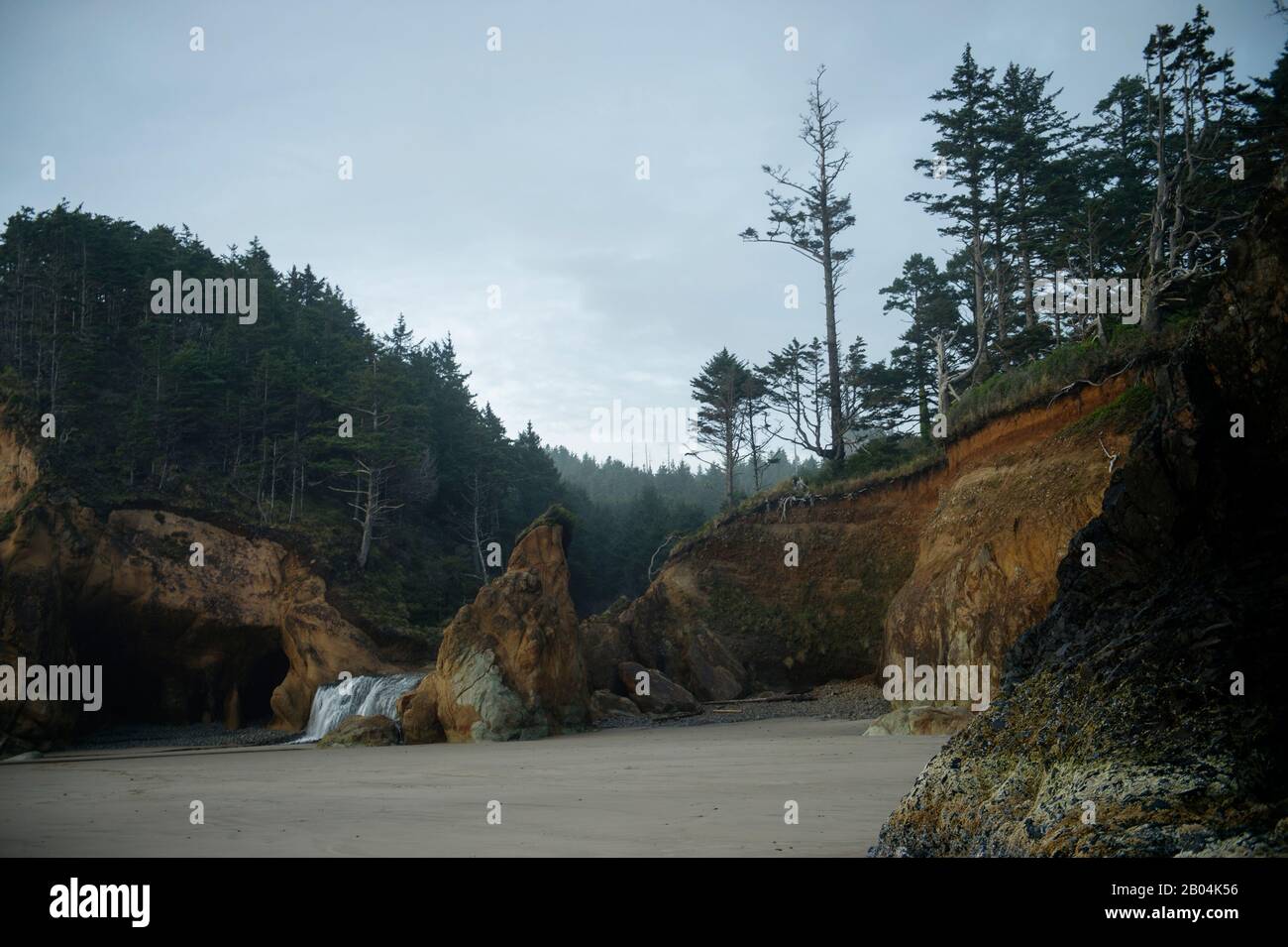 View of waterfall at Hug Point State Park near Cannon Beach in Oregon ...