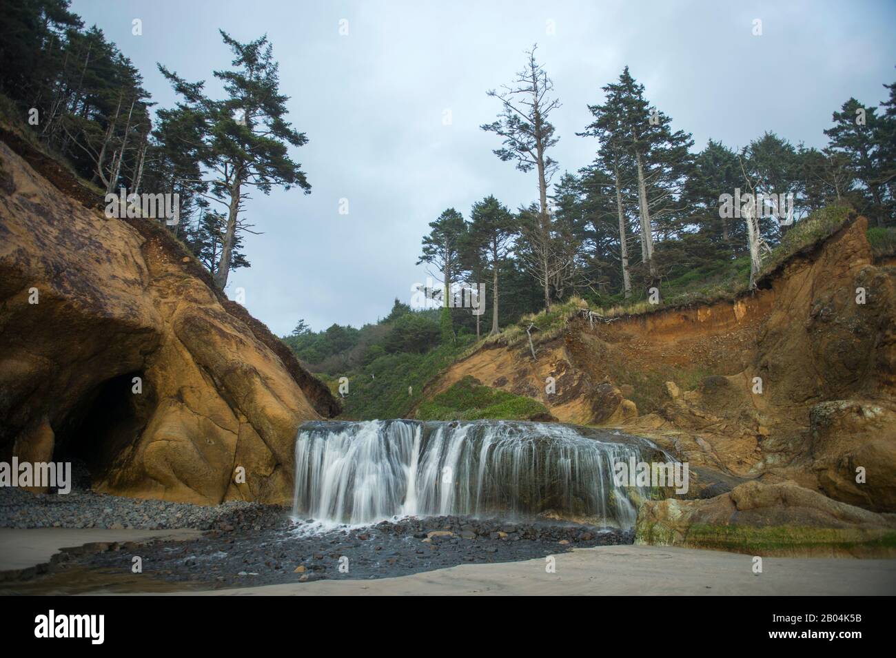 View of waterfall at Hug Point State Park near Cannon Beach in Oregon ...