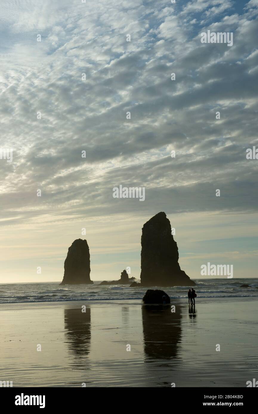 People walking on Cannon Beach on the Northern Oregon Coast, USA with ...