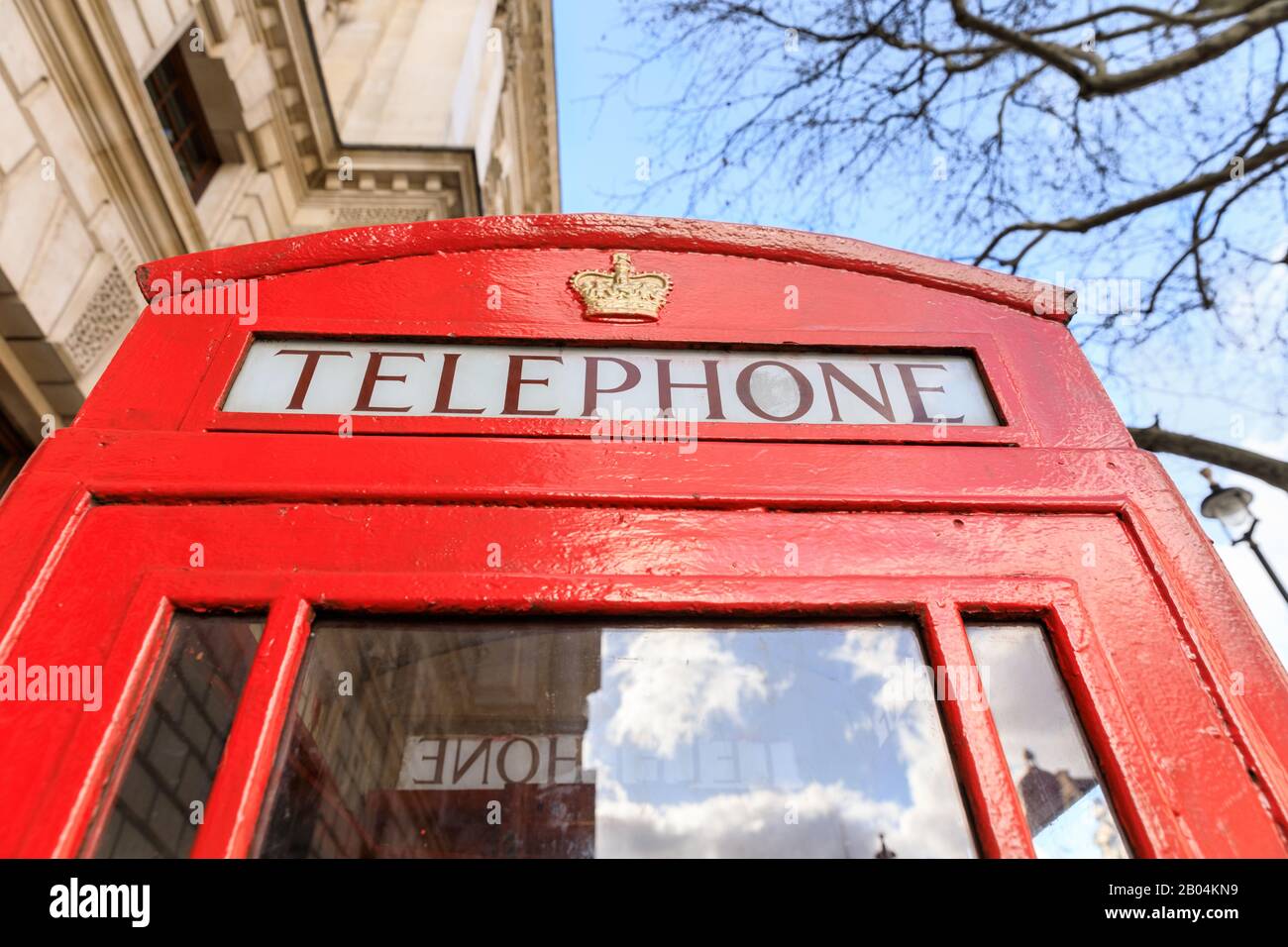 Top of iconic British red telephone box against historic buildings in ...