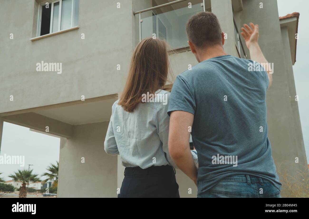 Real estate agent shows the development to his client Stock Photo - Alamy