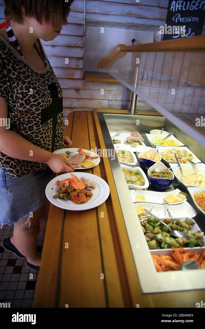 A woman choosing food at a buffet in a restaurant, France Stock Photo ...