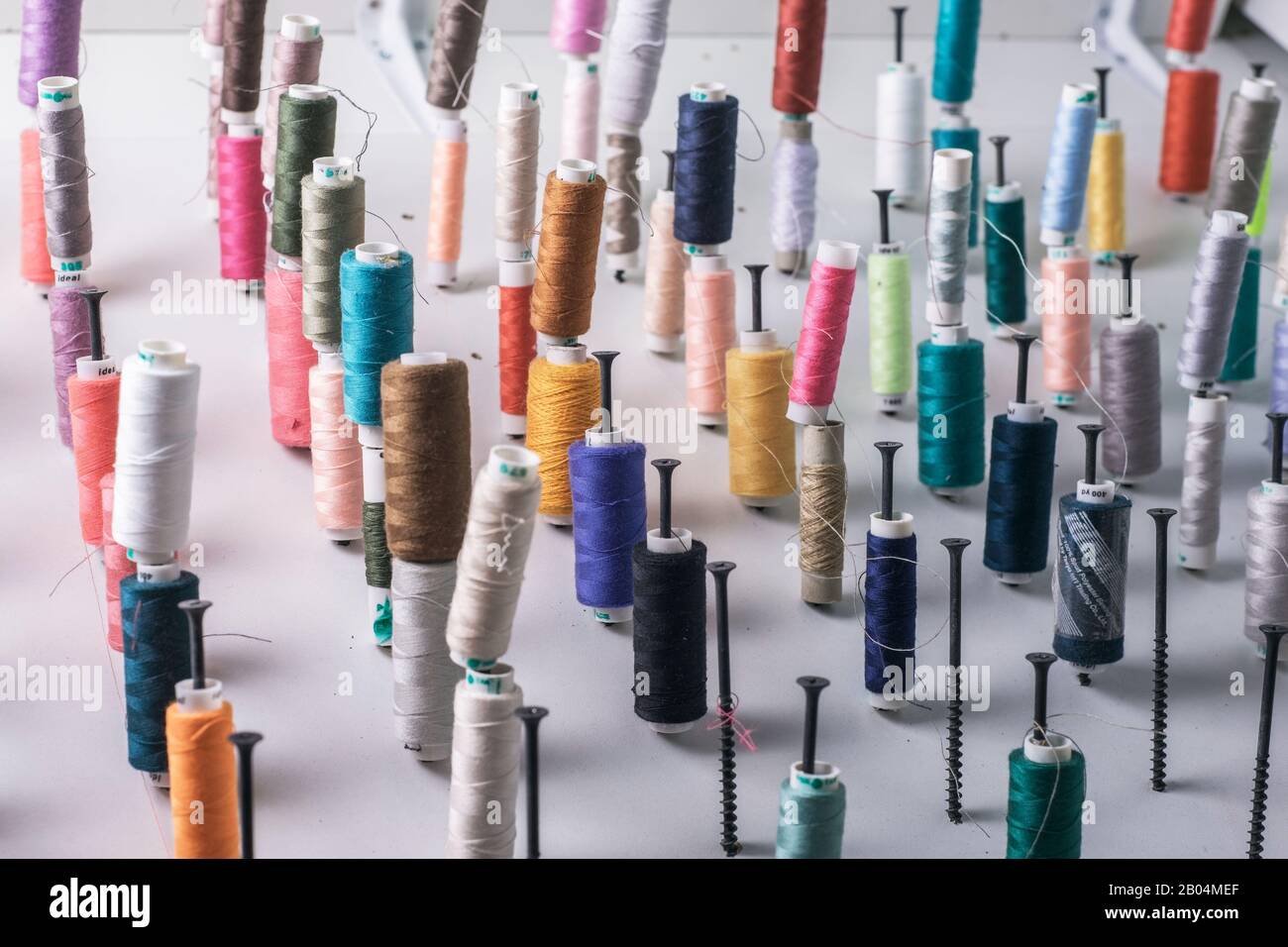 Sewing threads multicolored background closeup multi-colored sewing ...