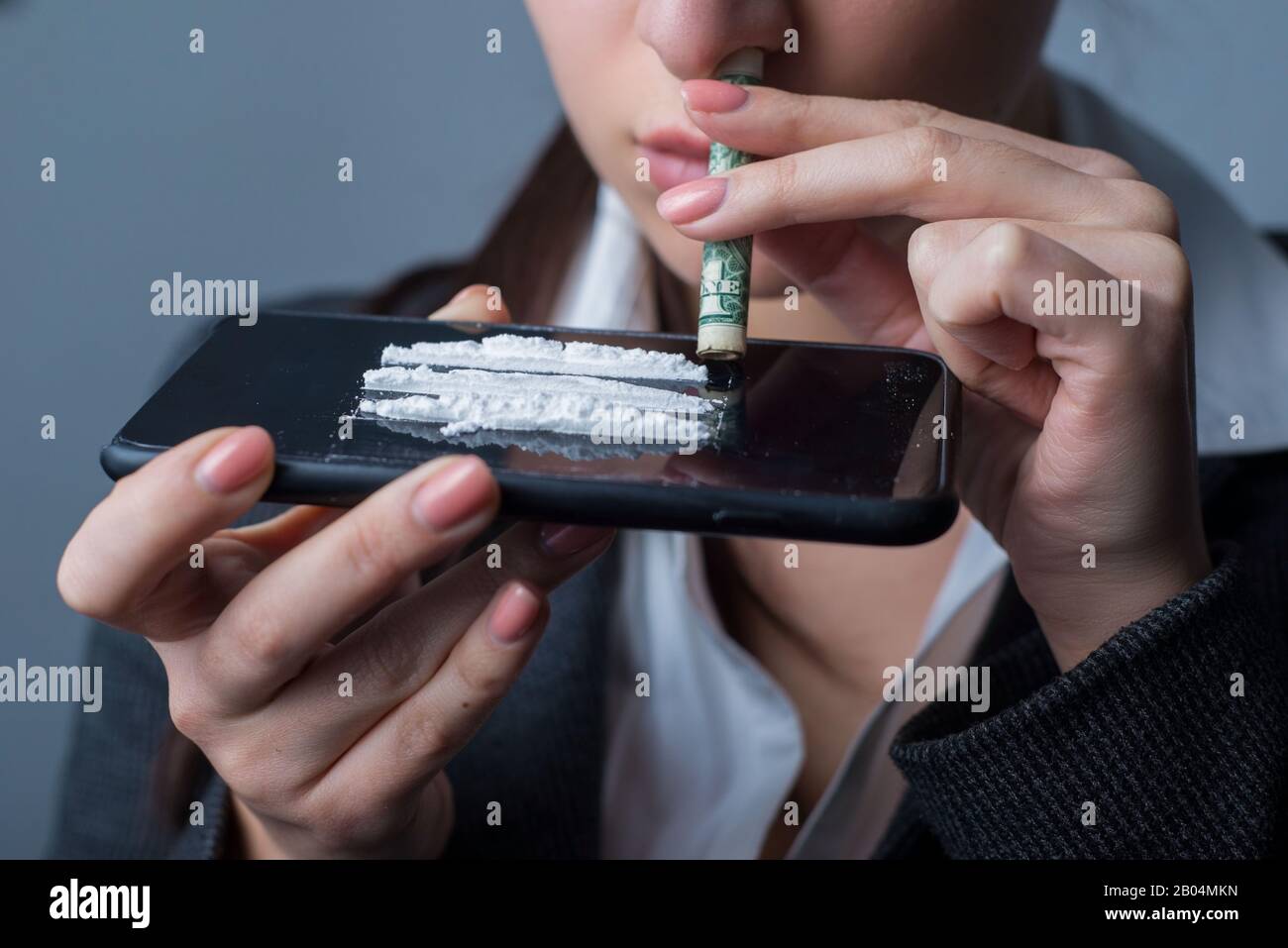 Portrait of a young cocaine girl using coca powder and a straw from a ...