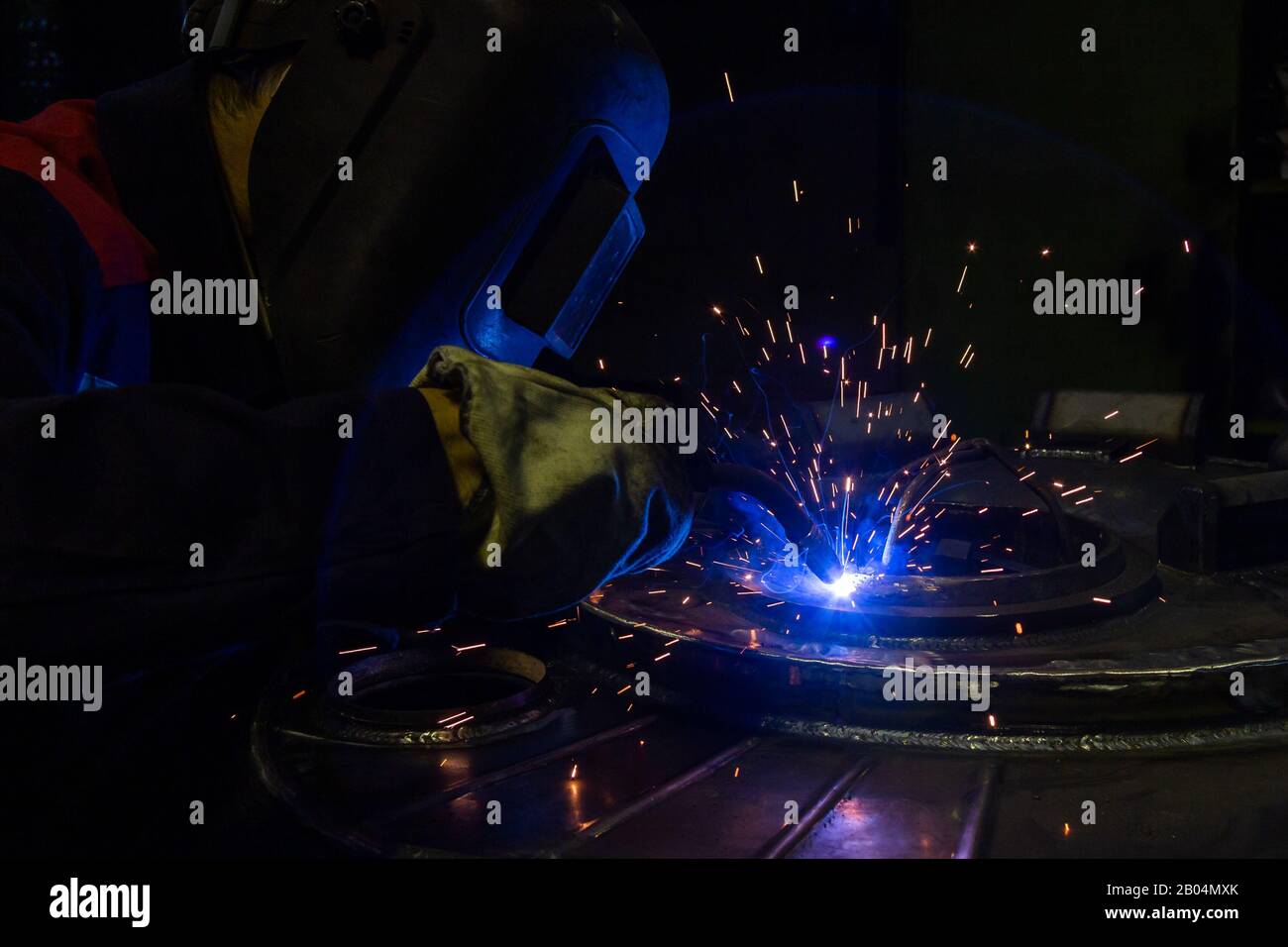 A lens flare while manual semi-automatic electric welding with sparks ...