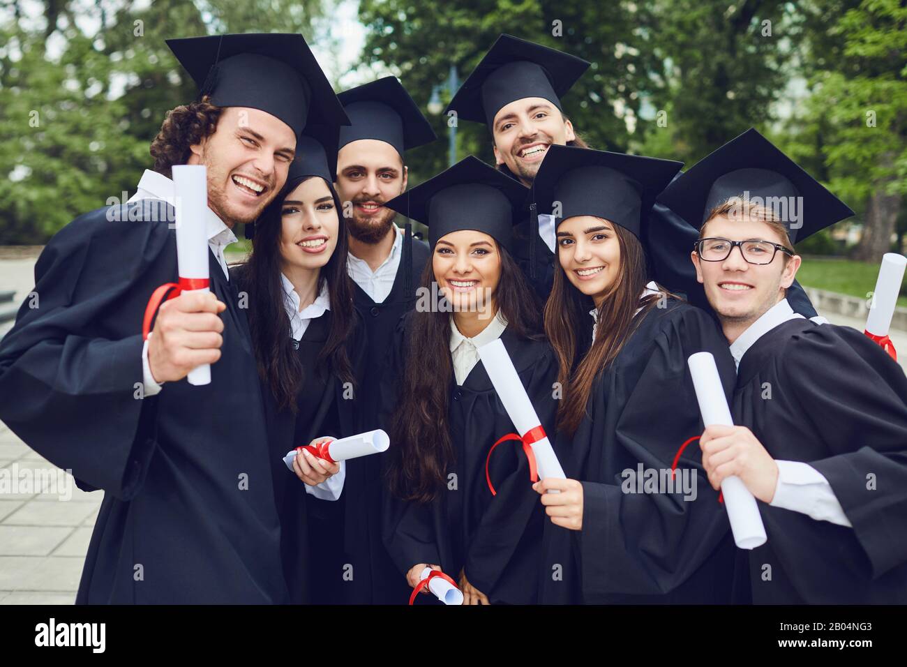 A group of graduates smiling Stock Photo - Alamy
