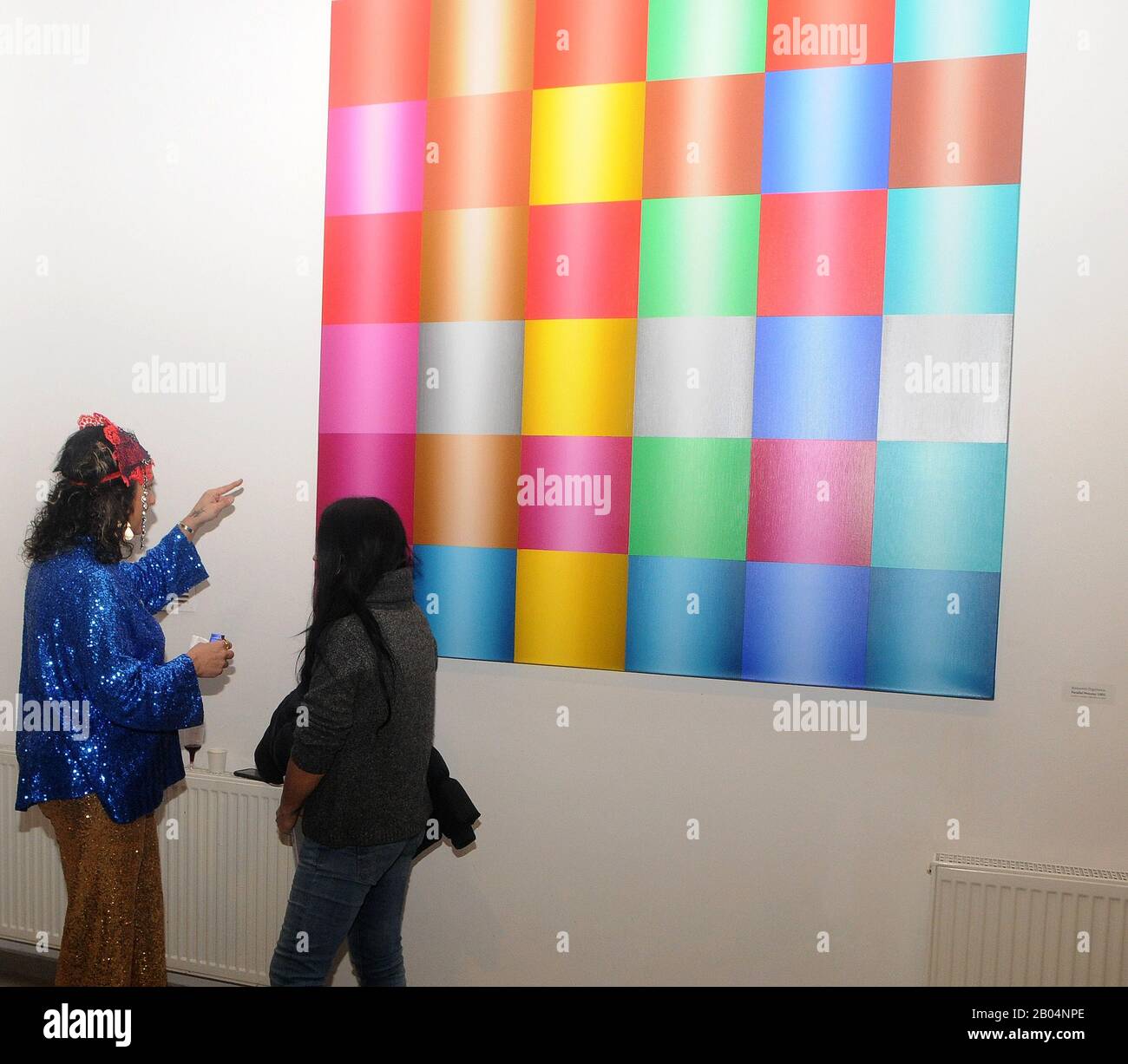 Visitors view a painting during the exhibition.Turkish artist, Bedri ...
