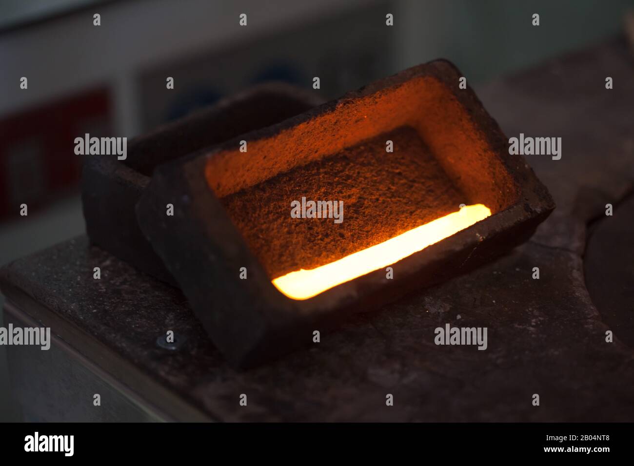 closeup picture of melt liquid metal in mold, glowing red-hot, nobody ...