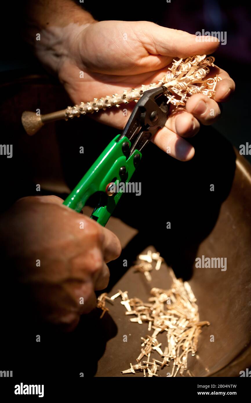 making jewellery, macro photo of hands holding cast golden parts for ...