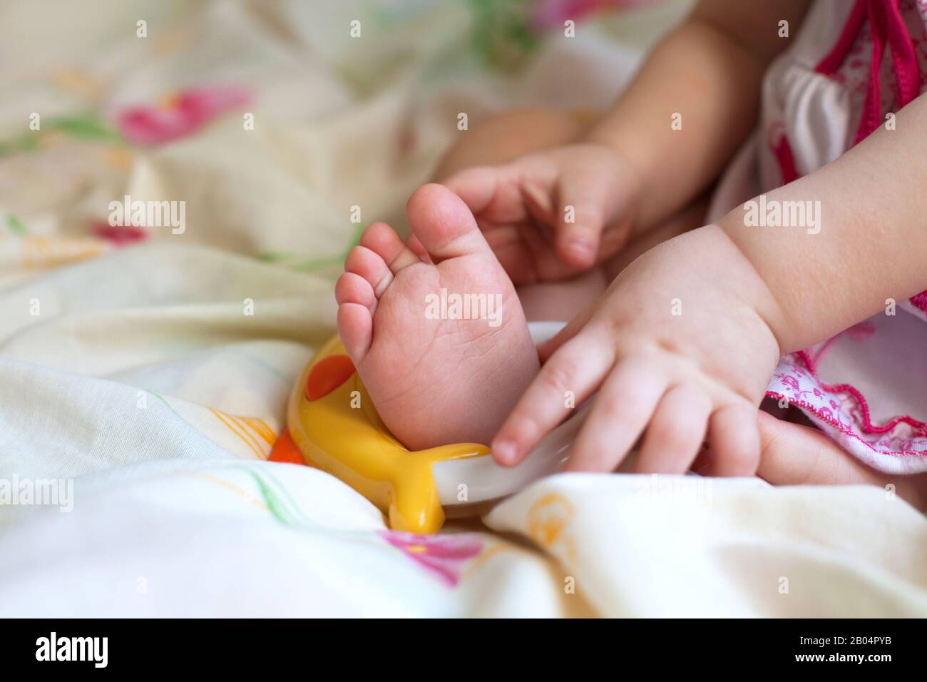 A child playing with a toy, puts it on the leg, selective focus Stock ...