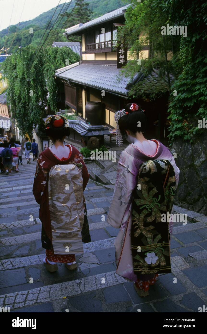 Street scene with a geisha walking down steps in the historic Gion ...