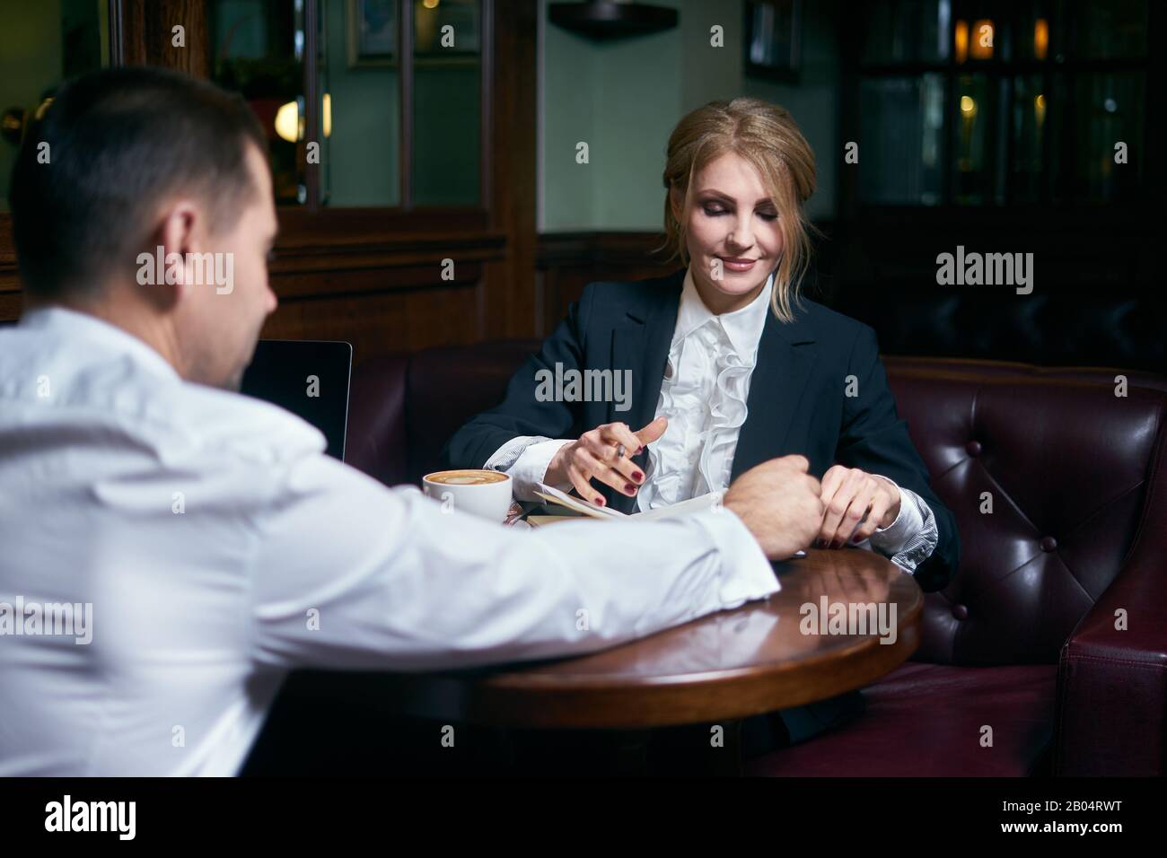 Business people talking over coffee in a cafe Stock Photo - Alamy