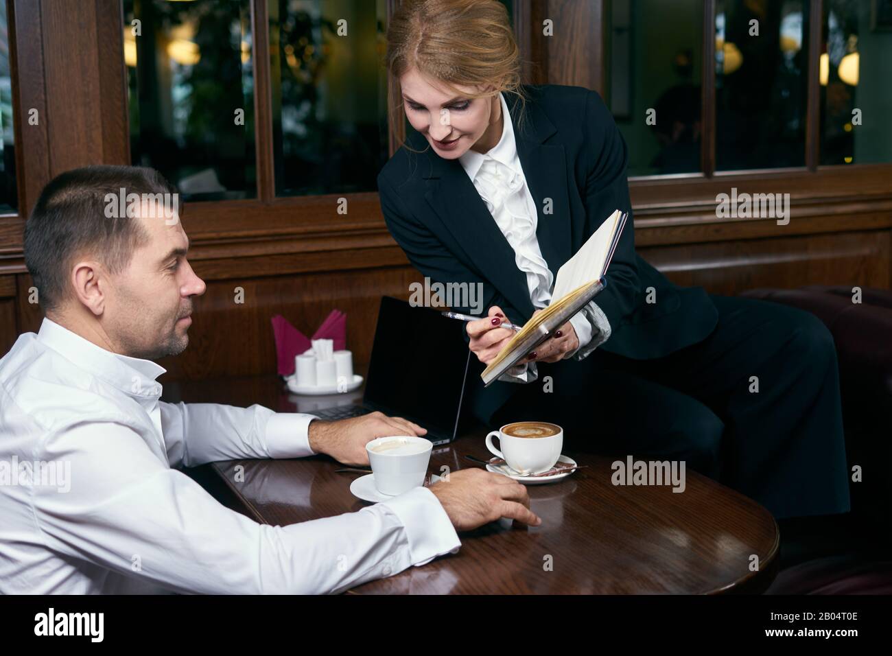 Business people talking over coffee in a cafe Stock Photo - Alamy