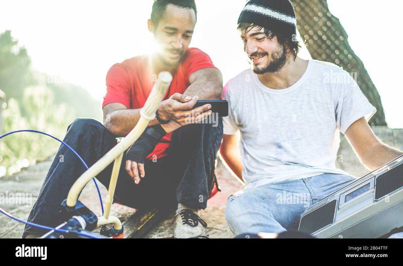 Bikers friends watching videos feed of their performances in city park ...