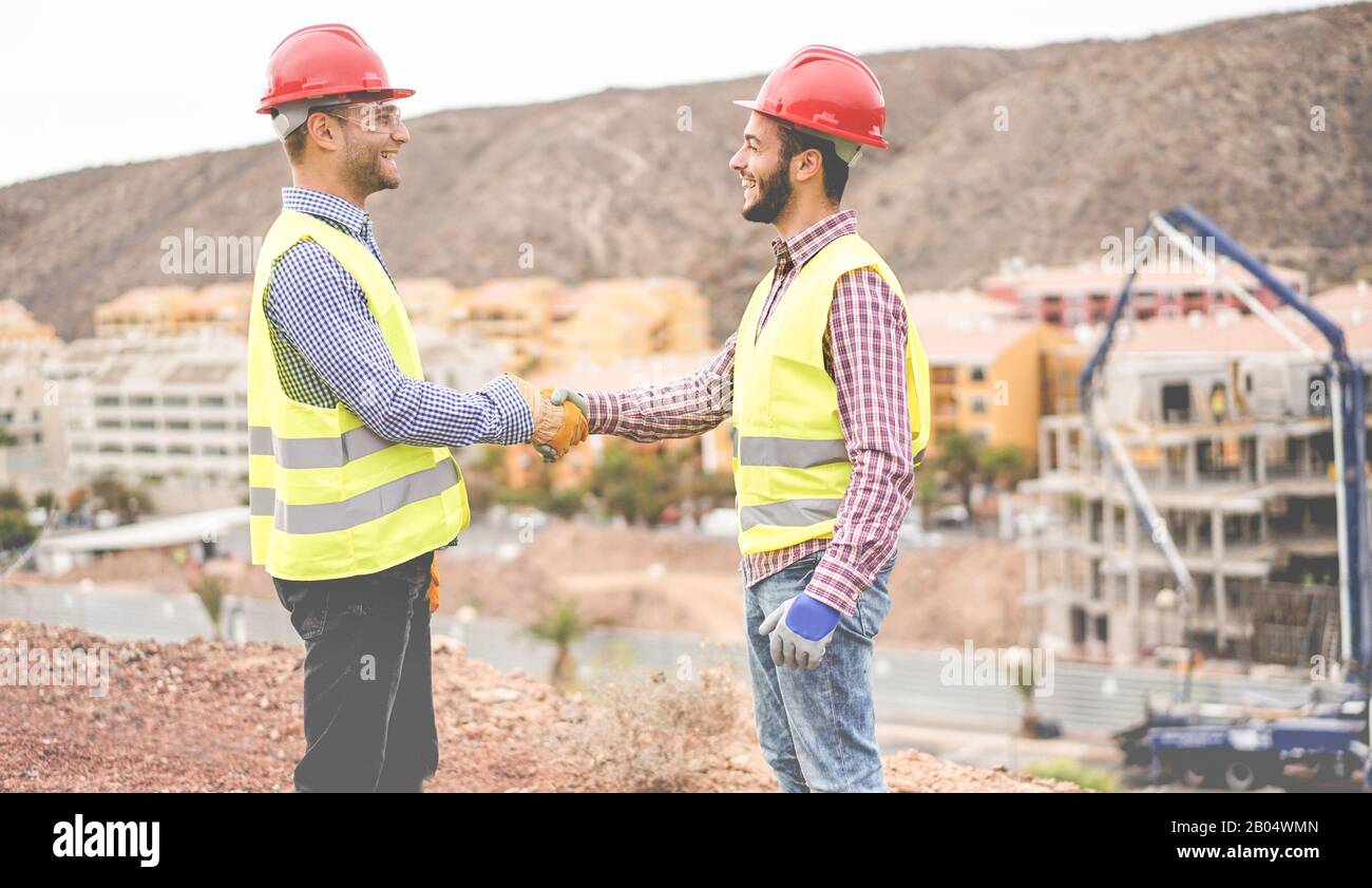 Builders on residential construction site making a deal - Happy workers ...