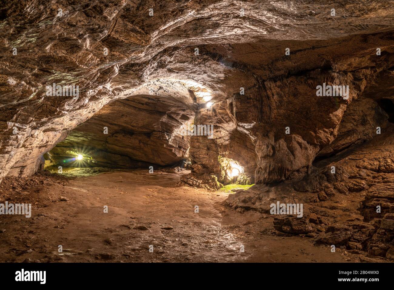 View inside the ancient cave with stone walls with additional lighting ...
