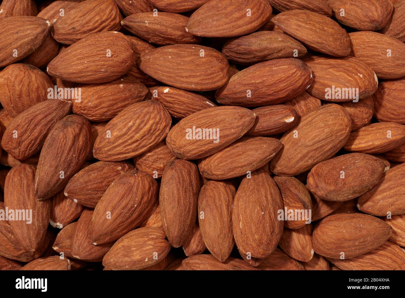 Whole almonds in skins on flat surface Stock Photo - Alamy