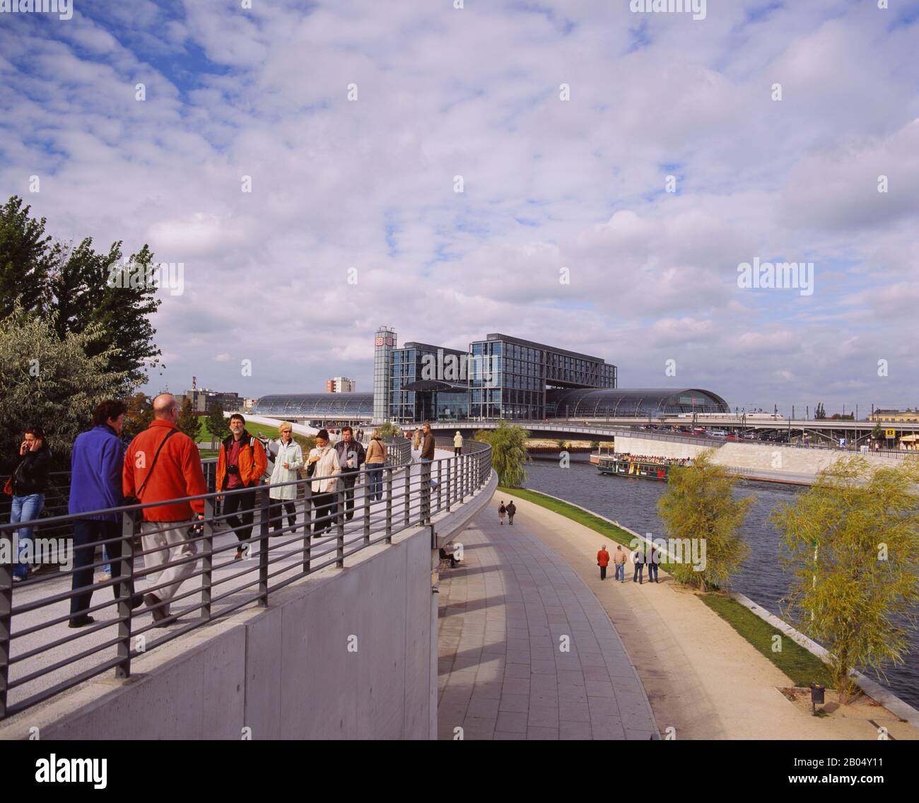 Group of people walking on a footpath along a river, Spree River ...