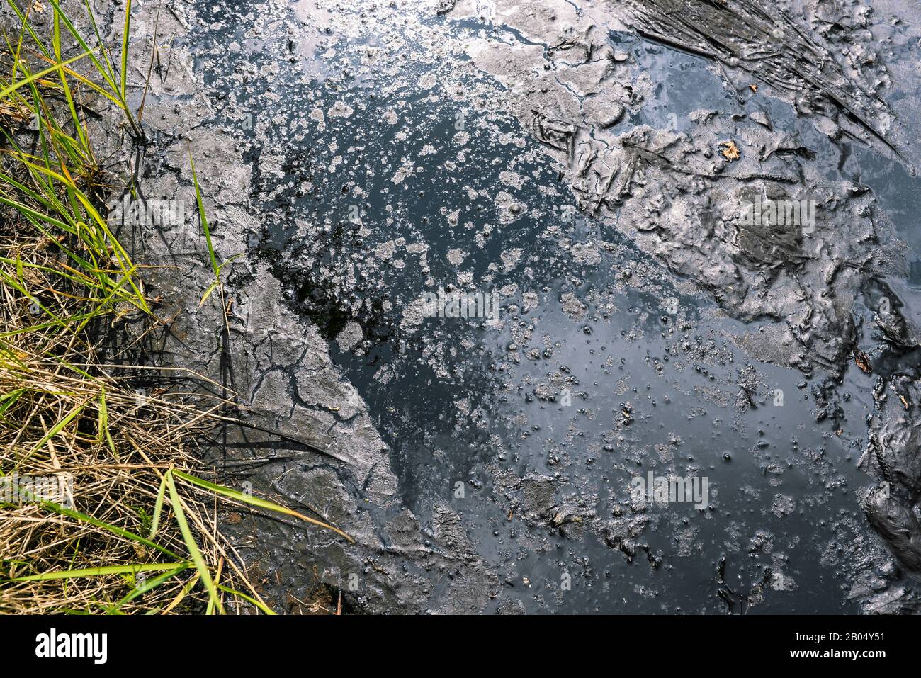 Oil spill on the ground. Environmental pollution by chemicals ...