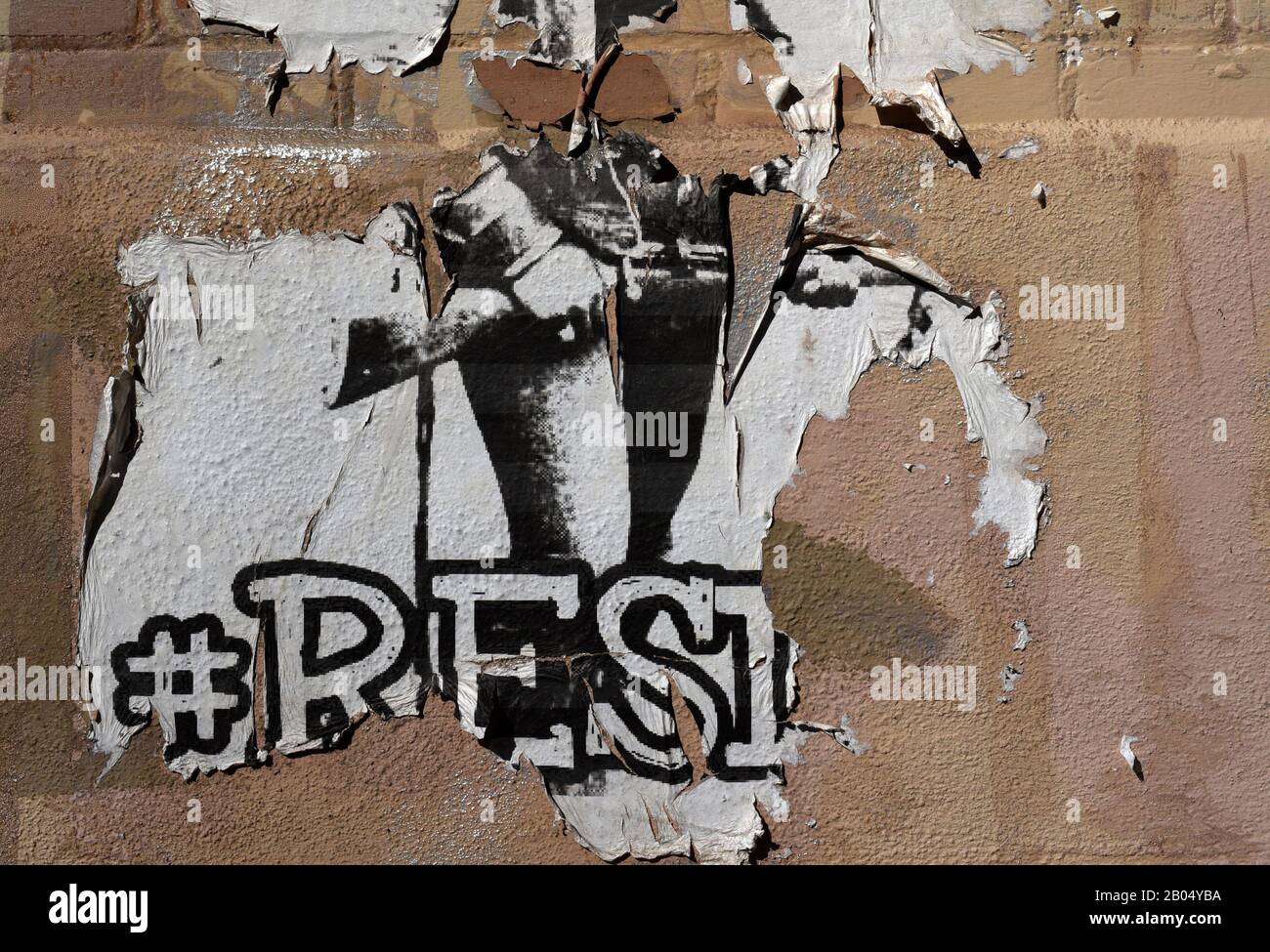 The remnants of a 'Resist' poster depicting a Native American woman ...