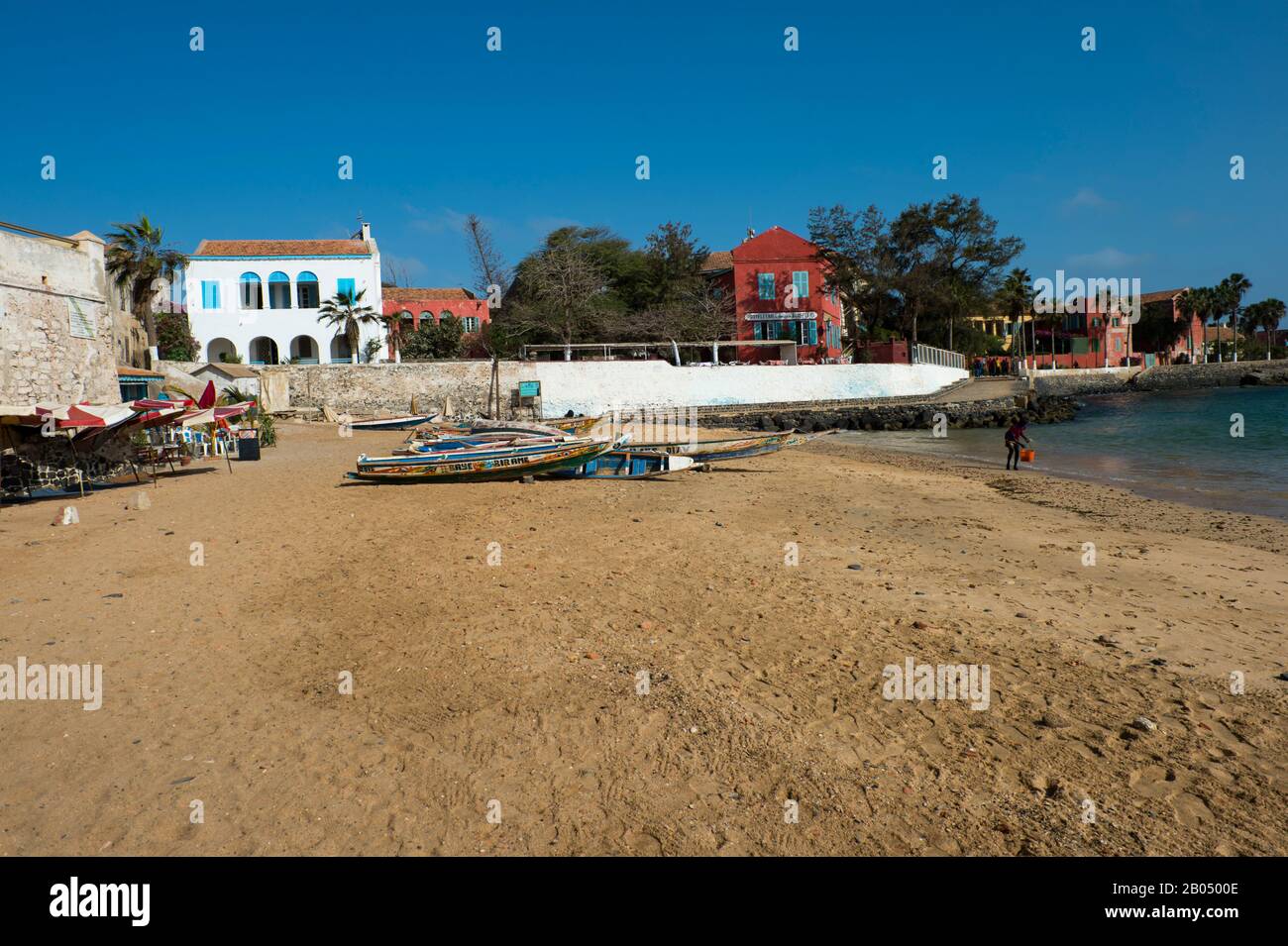 Colorful wooden fishing boats on the small beach at the harbor of Goree ...